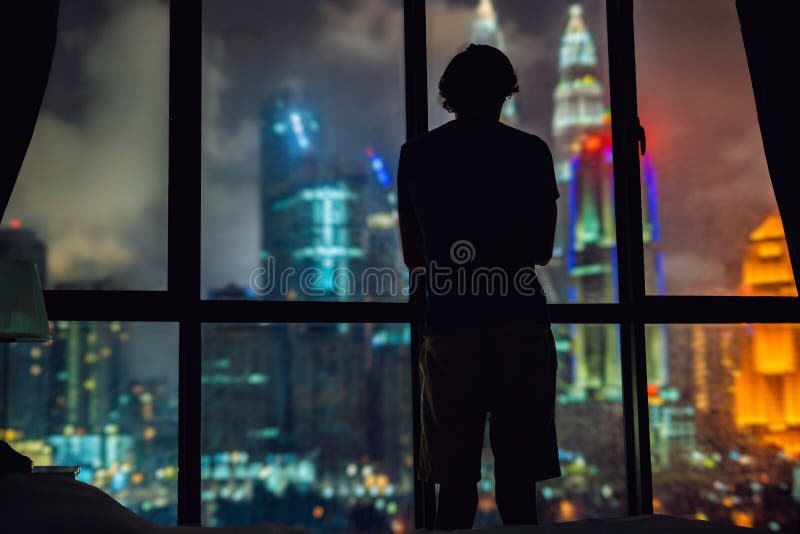 Man Looks Out the Window at the Night City Stock Photo - Image of ...