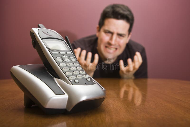 Man Looks at the Phone Frustrated Stock Photo - Image of plead, tshirt ...