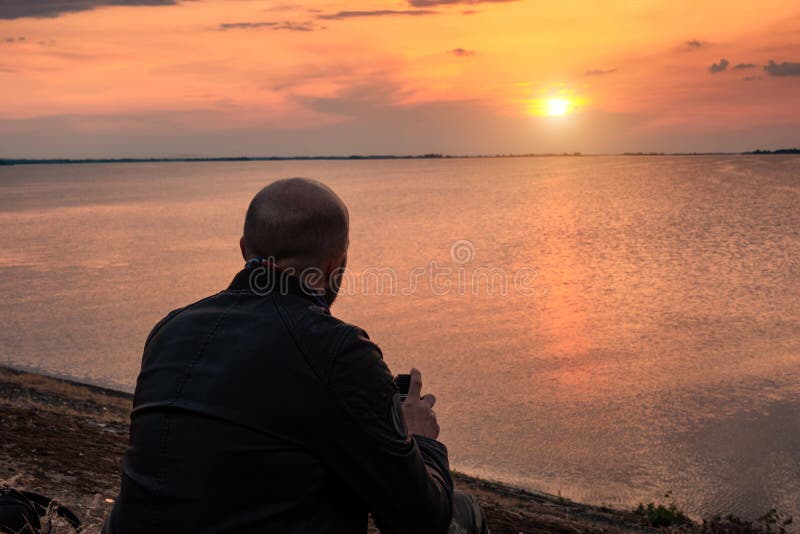 A Man Looks at the Sea at Sunset Day Stock Image - Image of sitting ...