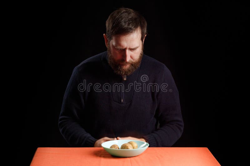 The Man Looks at the Table on Which a Plate of Potatoes in it Stock ...