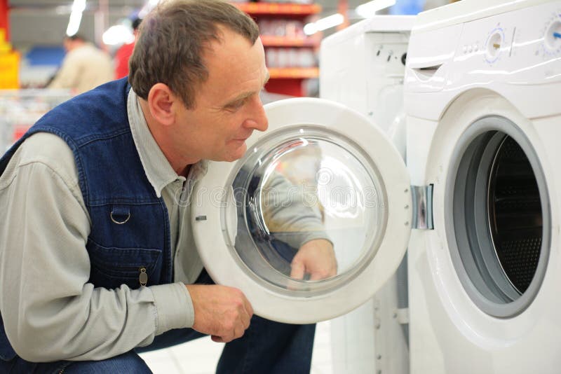 Man Looks Washing Machine Stock Photos - Free & Royalty-Free Stock ...