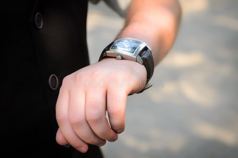 The man looks watch stock image. Image of bride, suit - 64533779