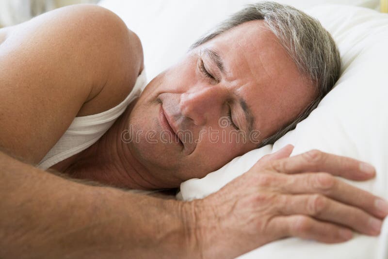 Man lying in bed sleeping stock photo. Image of nightclothes - 5547358