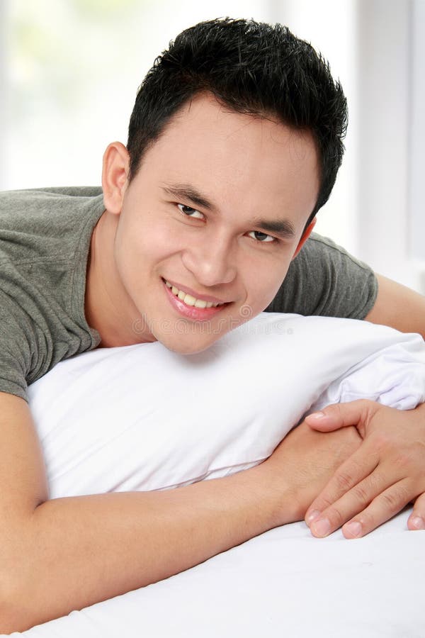 Man lying in bed smiling stock photo. Image of nightwear - 24237452
