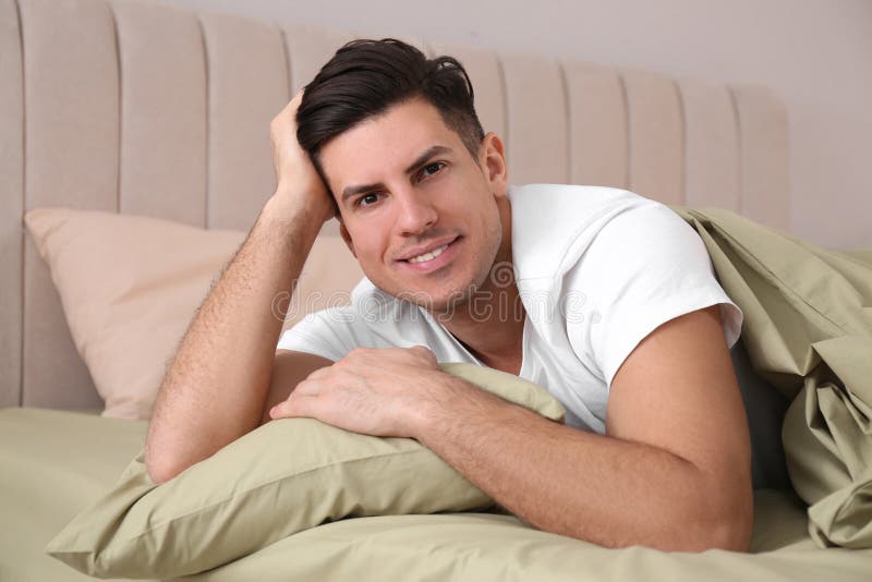 Man Lying in Comfortable Bed with Green Linens Stock Image - Image of ...