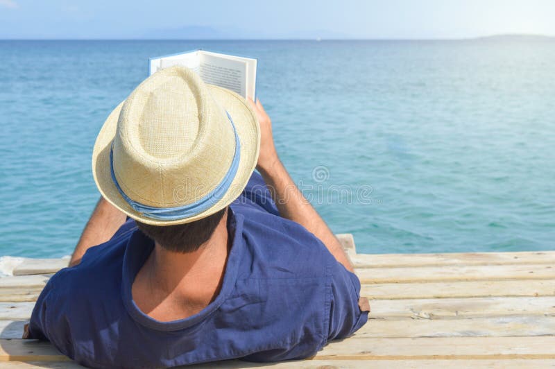 Man Lying on the Dock and Reading a Book Stock Photo - Image of summer ...