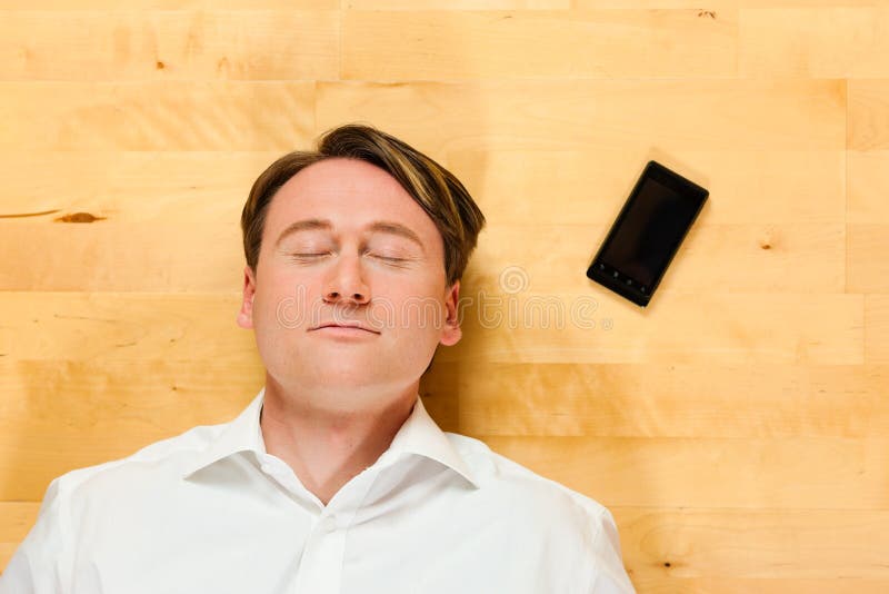 Man Lying on the Floor beside Mobile Phone Stock Photo - Image of life ...