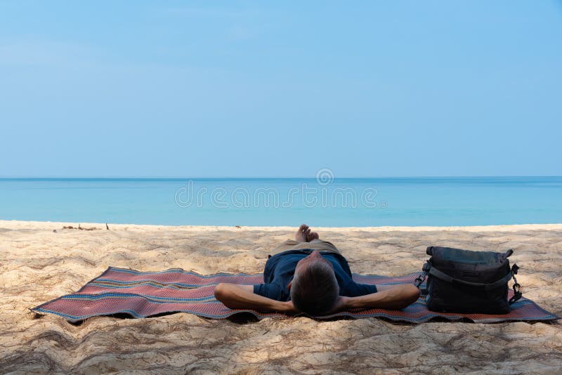 A Man Lying on a Mat by the Quiet Sea Stock Photo - Image of asian ...