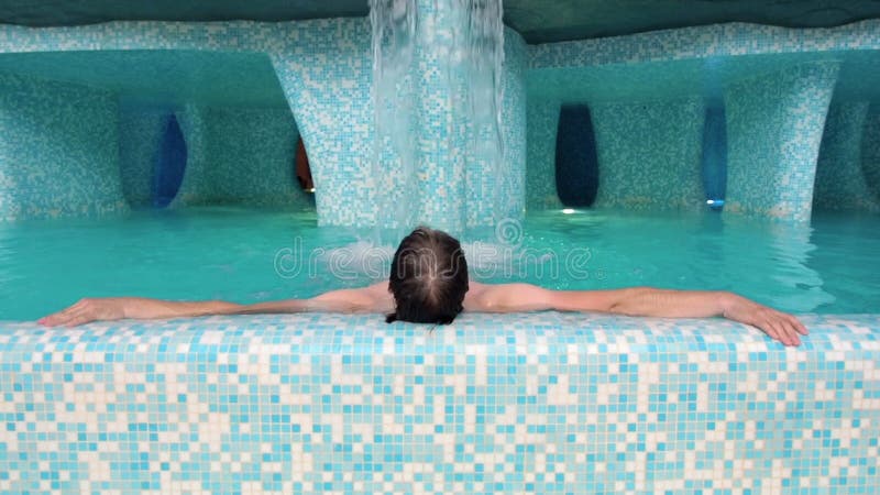 The Man is Lying Relaxes in the Swimming Pool. Caucasian Man Resting in ...