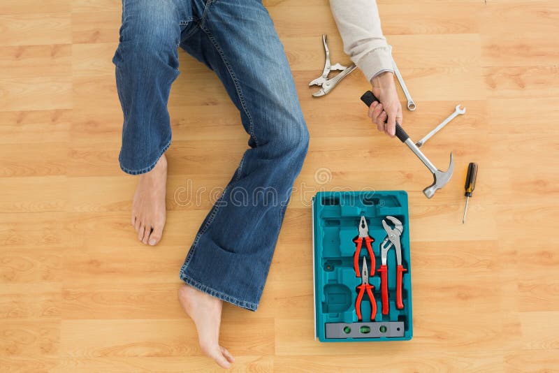Man Lying with Several Tools on Parquet Floor Stock Photo - Image of ...