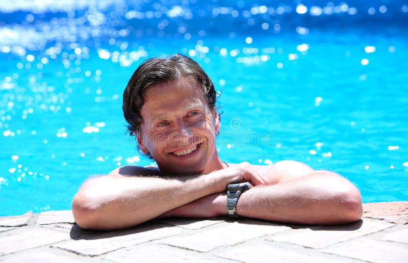 Man Lying on Side of Swimming Pool in the Sun Stock Image - Image of ...