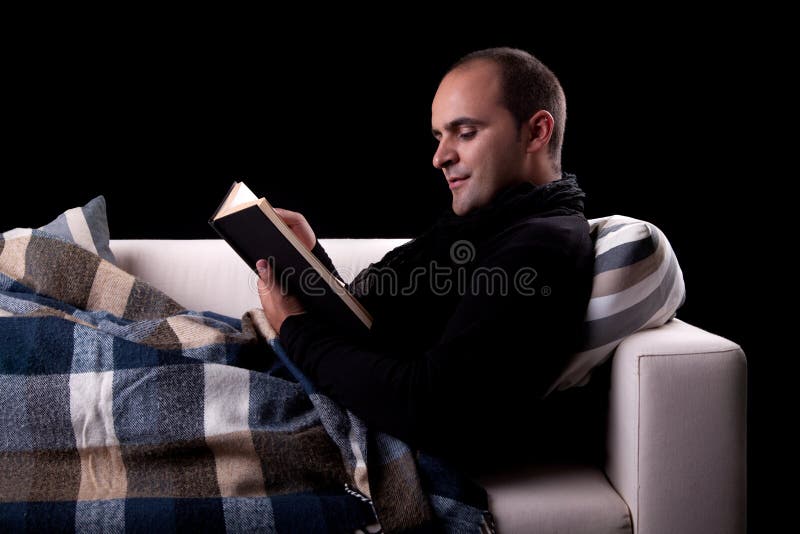 Man Lying on the Sofa Reading a Book, Stock Image - Image of enjoying ...