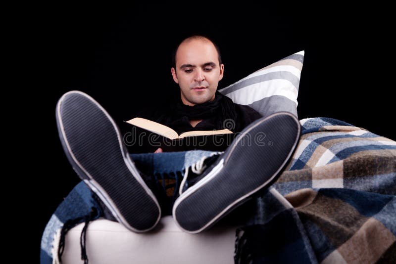 Man Lying on the Sofa Reading a Book, Stock Photo - Image of indoors ...