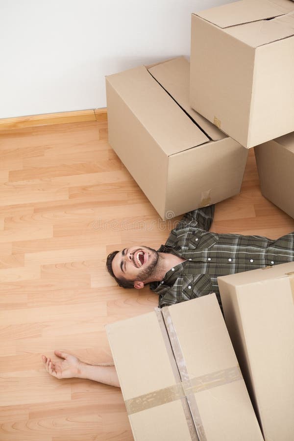 Man Lying Under Fallen Boxes Stock Image - Image of room, lifestyle ...