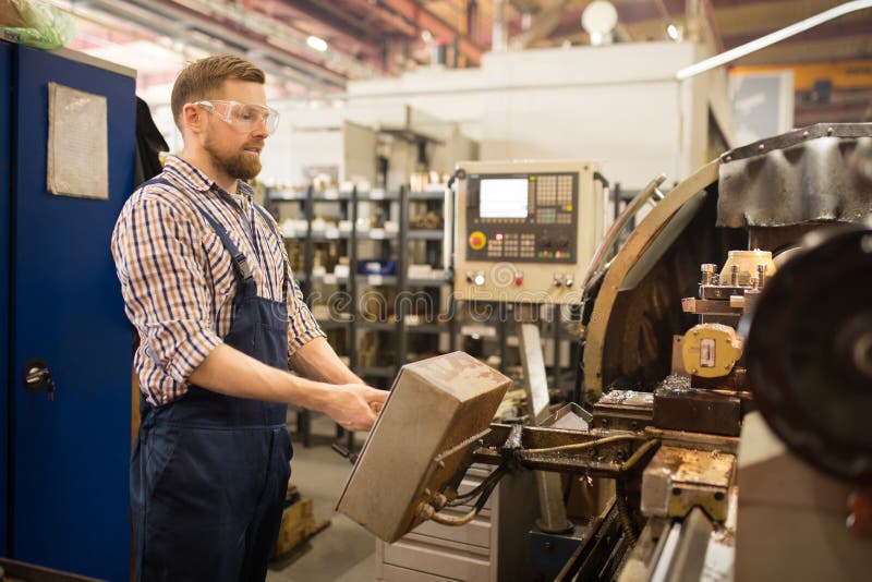 Man by machine stock photo. Image of overalls, manufacturing - 144211090