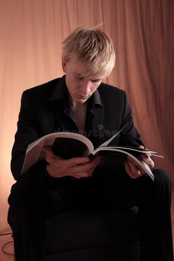 Man and magazine stock image. Image of black, sitting - 6240007