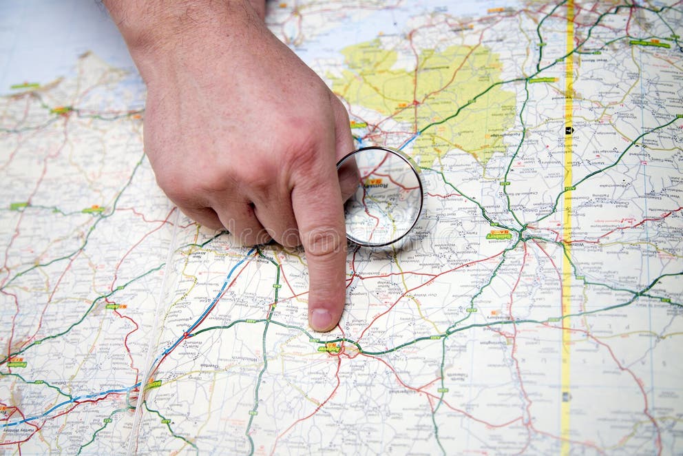 Man with Magnifier Pointing on a Map Stock Photo - Image of pointing ...