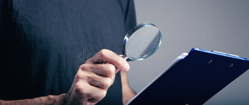 A Man with a Magnifying Glass Looks at Papers Stock Image - Image of ...