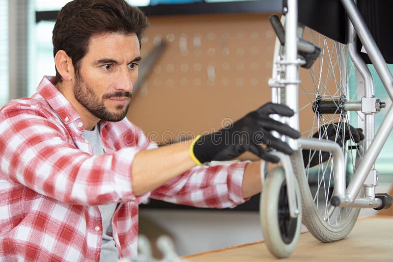 Man Maintaining Wheelchair Raised on Bench Stock Photo - Image of adult ...