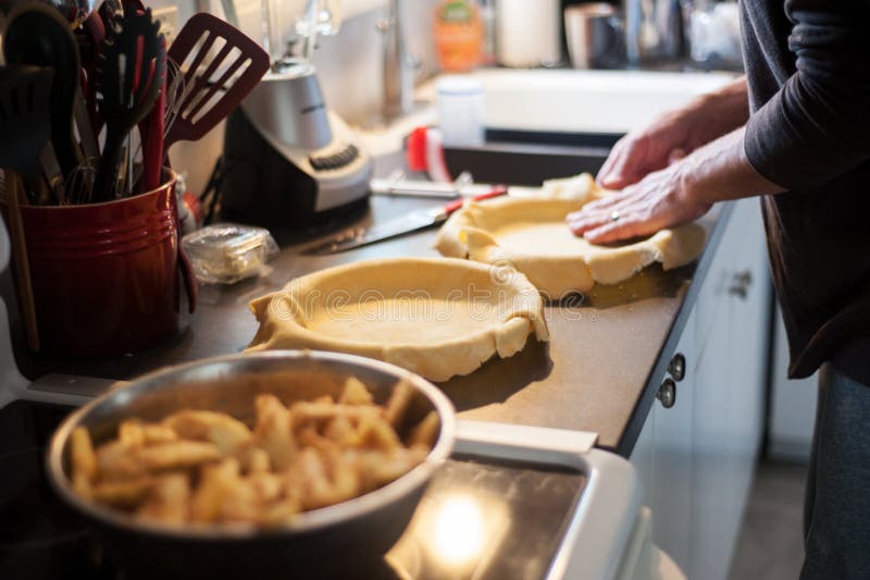 A Man Makes Apple Pies in a Kitchen Stock Photo - Image of detail, hand ...