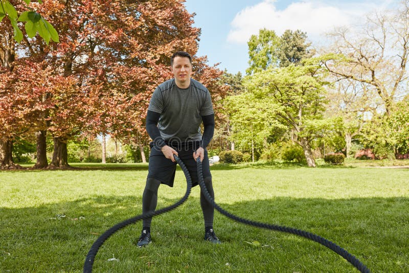 Man Makes Battle Rope Training at Park Stock Photo - Image of garden ...