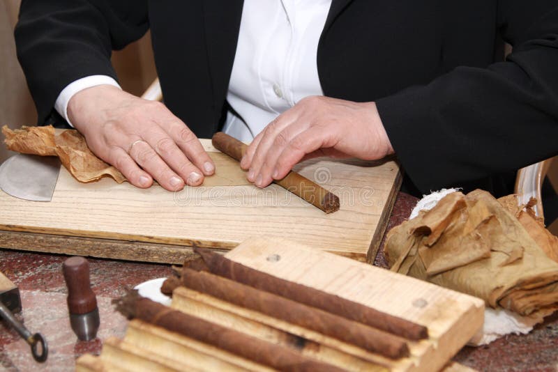 Man makes cigars stock image. Image of knife, craft - 122443647