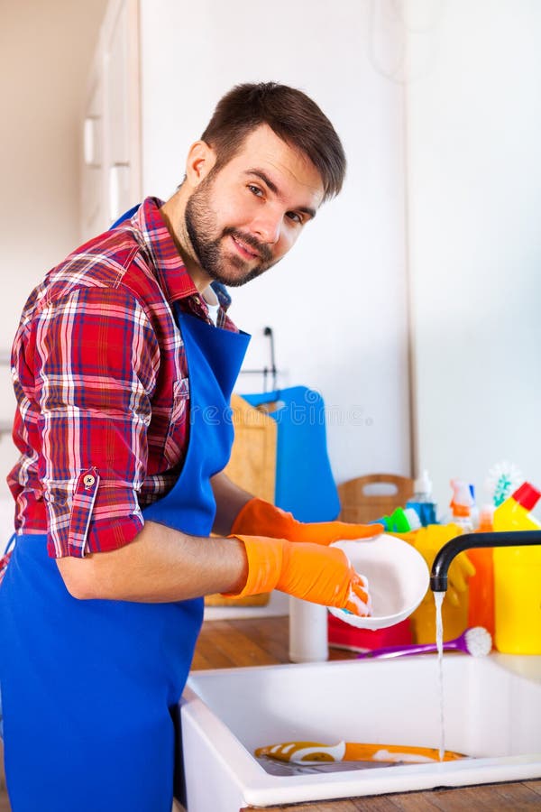 Man Makes Cleaning the Kitchen. Young Man Washes the Dishes. Cleaning ...