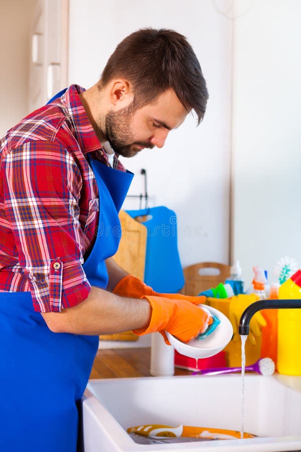 Man Makes Cleaning the Kitchen. Young Man Washes the Dishes. Cleaning ...