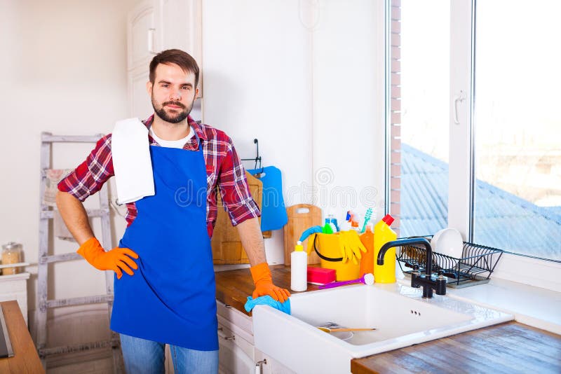 Man Makes Cleaning the Kitchen. Young Man Washes the Dishes. Cleaning ...