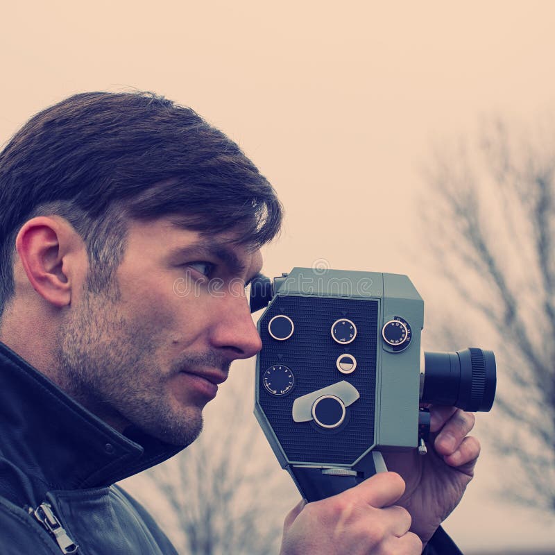 Man makes filming stock image. Image of holding, camera - 83475575