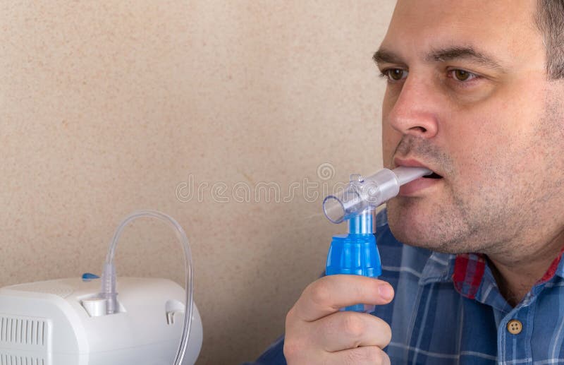 Man Makes Inhalations with the Help of Nebulizer. Patient Breathes ...