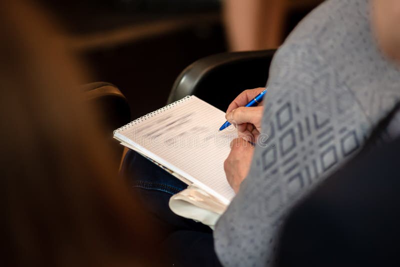 Man Makes Notes in a Notebook while Sitting at a Press Conference Stock ...