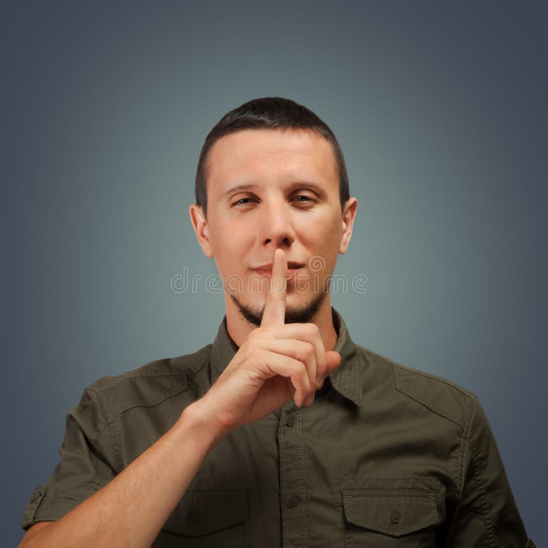 Young Man with Serious Expression Doing a Silent Sign Stock Photo ...