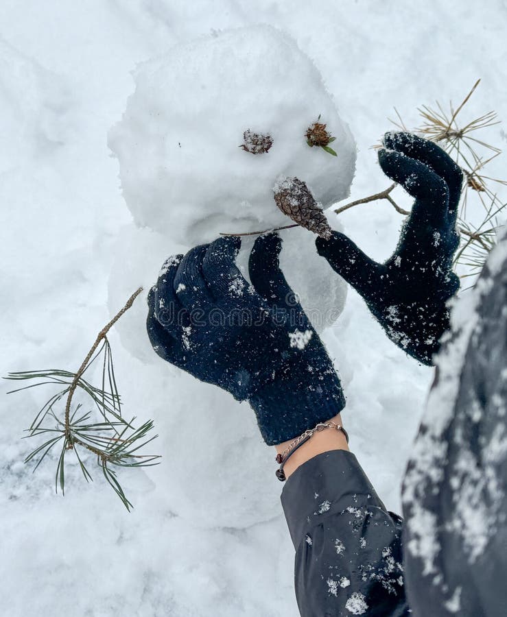 A Man Makes a Snowman Outdoors in Winter Stock Photo - Image of playful ...