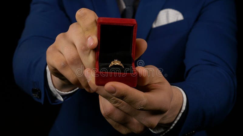 Hands of an Elegant Man Holding and Presenting Jewelry Box with Ring ...