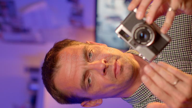 A Man is Making Adjustments To a Camera in a Studio Setting Lighting ...