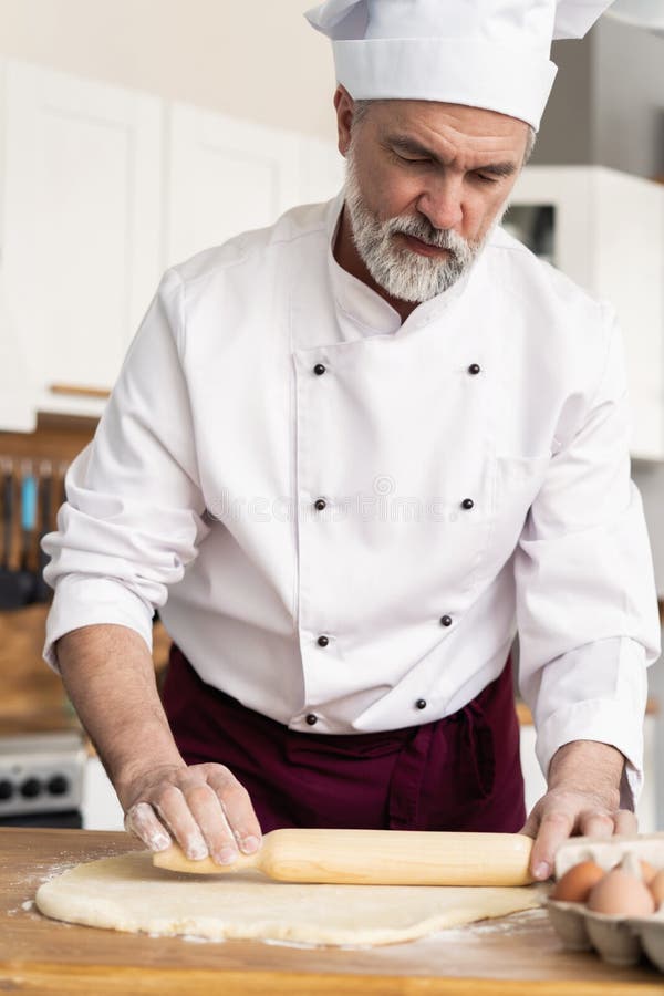 Man Making Bakery in the Kitchen and Rolling Dough on the Wooden ...
