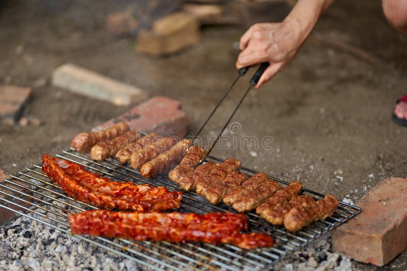 Man making a barbecue stock image. Image of charcoal - 190551933