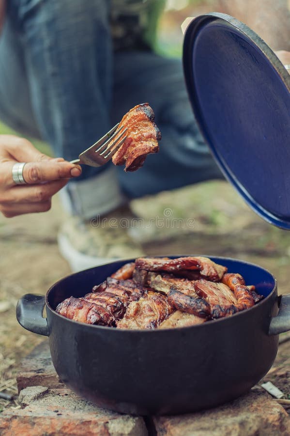 Man Making Barbecue and Puts Roasted Meats in the Pot Stock Photo ...