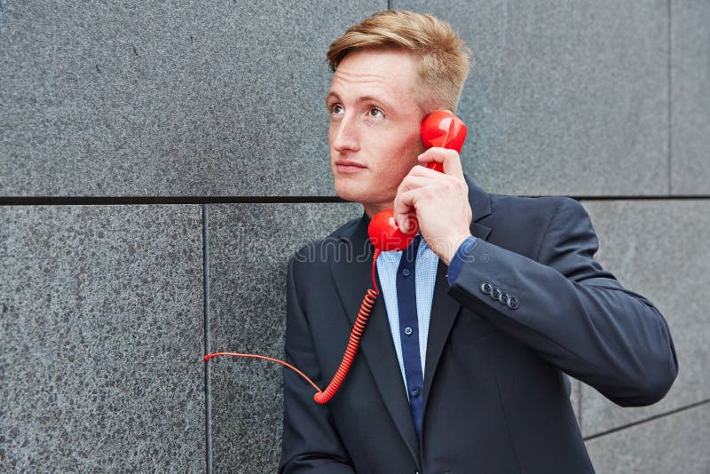 Man Making Call with Red Phone on Wall Stock Image - Image of cable ...