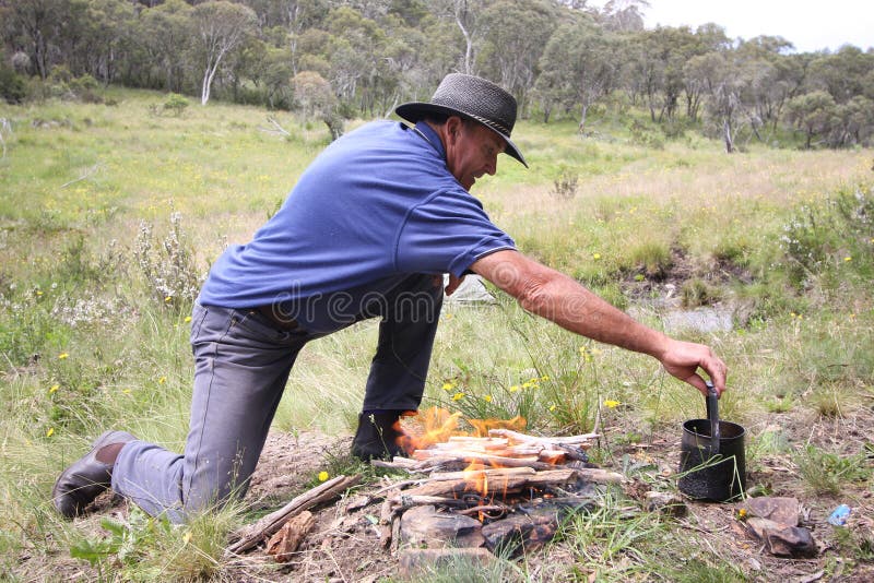 Man making campfire stock image. Image of cattlemen, mountains - 4807513