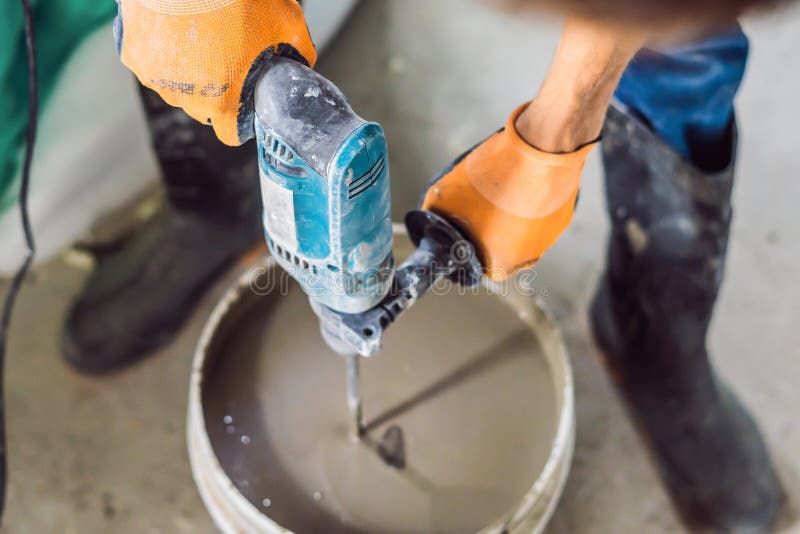 Man Making Cement with a Construction Mixer in a Bucket Stock Image ...