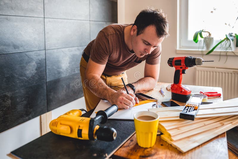 Man Making Draft Plan Using Pencil Stock Photo - Image of bits, phone ...