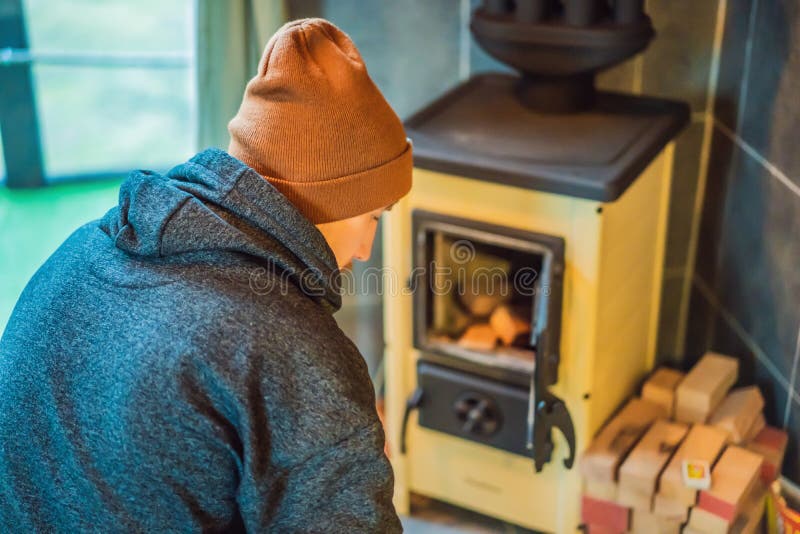 Man Making Fire in the Fireplace. Rest in the Mountains in Glamping ...