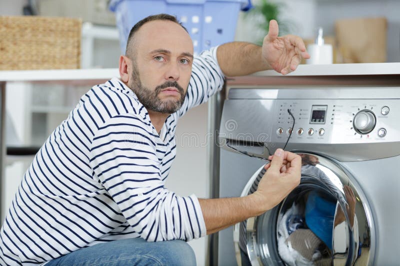 Man Making Gesture Incomprehension Towards Broken Washing Machine Stock ...