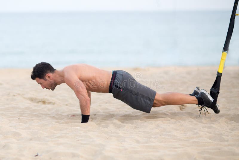 Man Making Leg Trx Exercise on the Beach Stock Photo - Image of curls ...