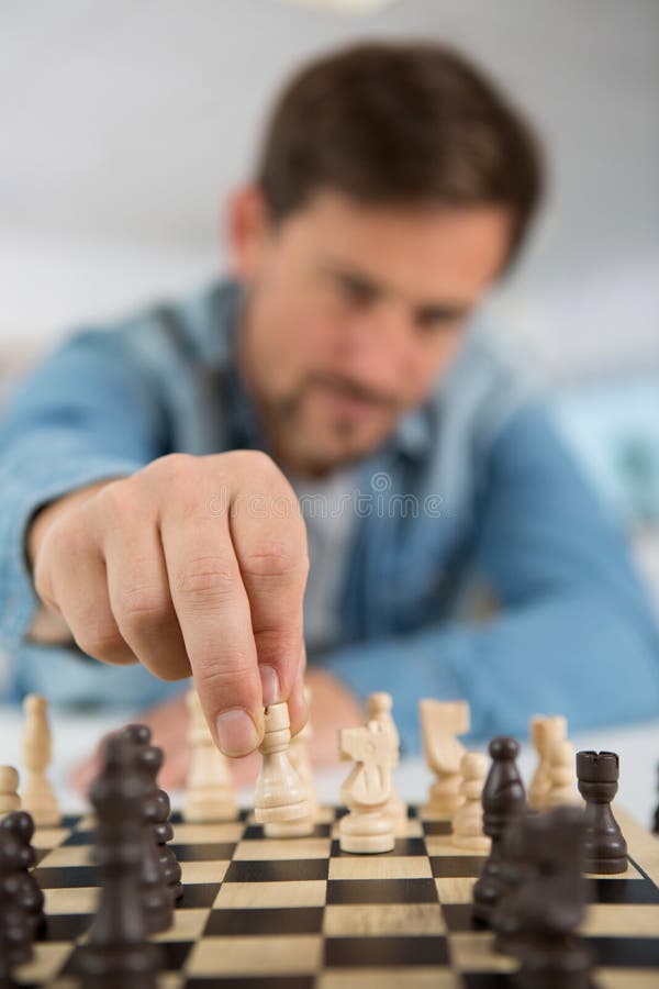 Man Playing Chess Making a Move Stock Image - Image of challenge ...