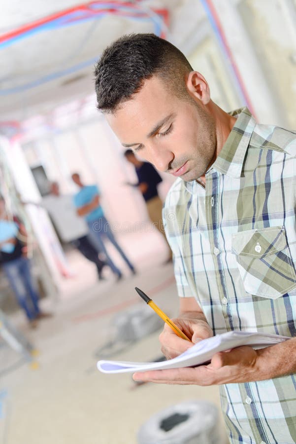 Man Making Notes Gathering at Construction Site Stock Image - Image of ...