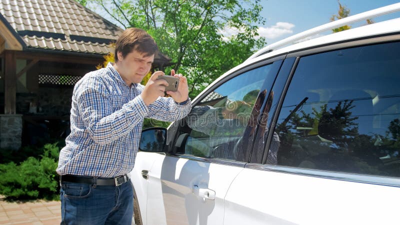Young Man Making Photos on Smartphone of His Car Stock Photo - Image of ...