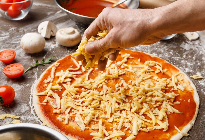 Man Making the Pizza, Adding Cheese on Pizza Base Stock Photo - Image ...